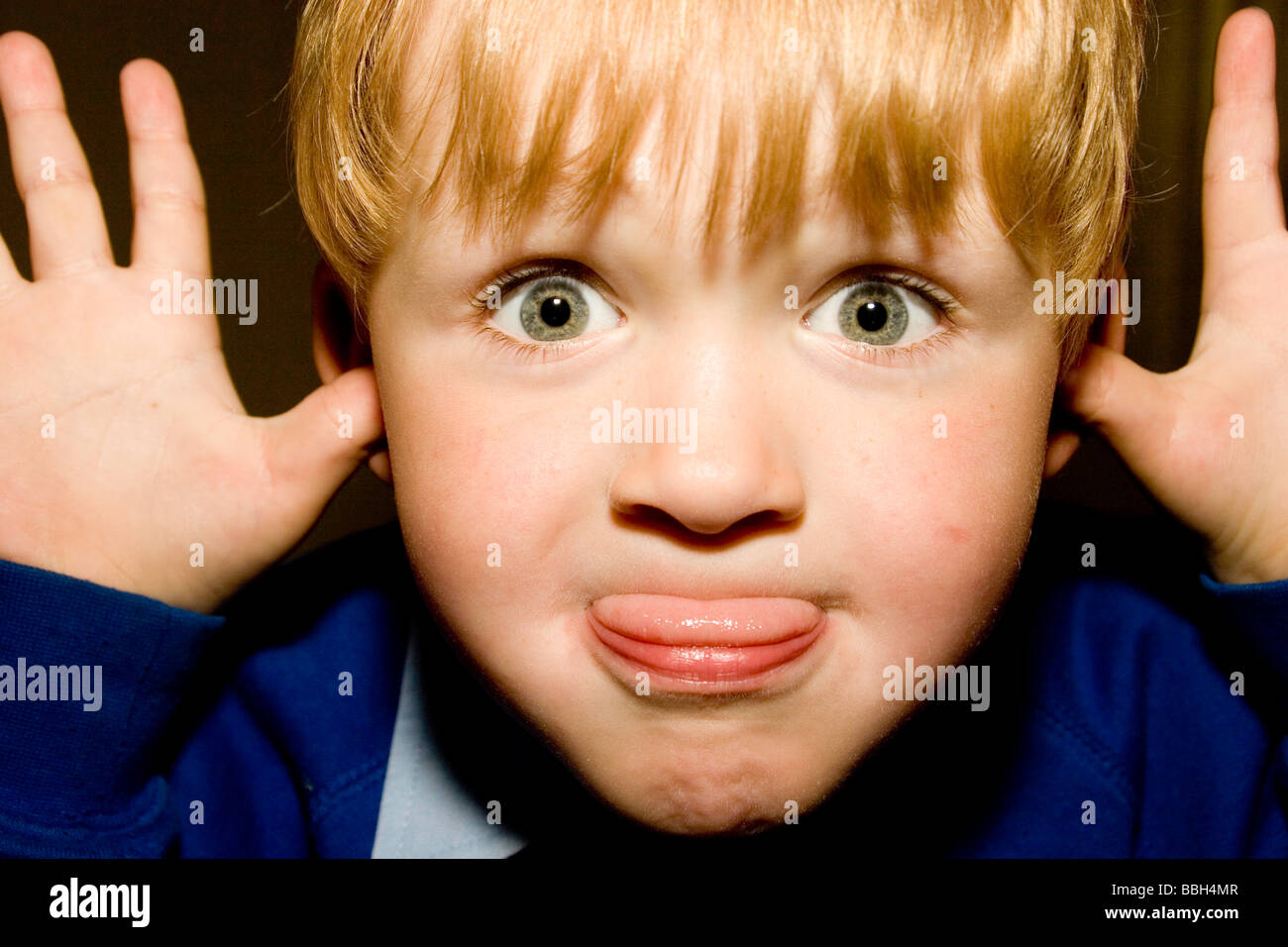 little boy pulling a face Stock Photo - Alamy