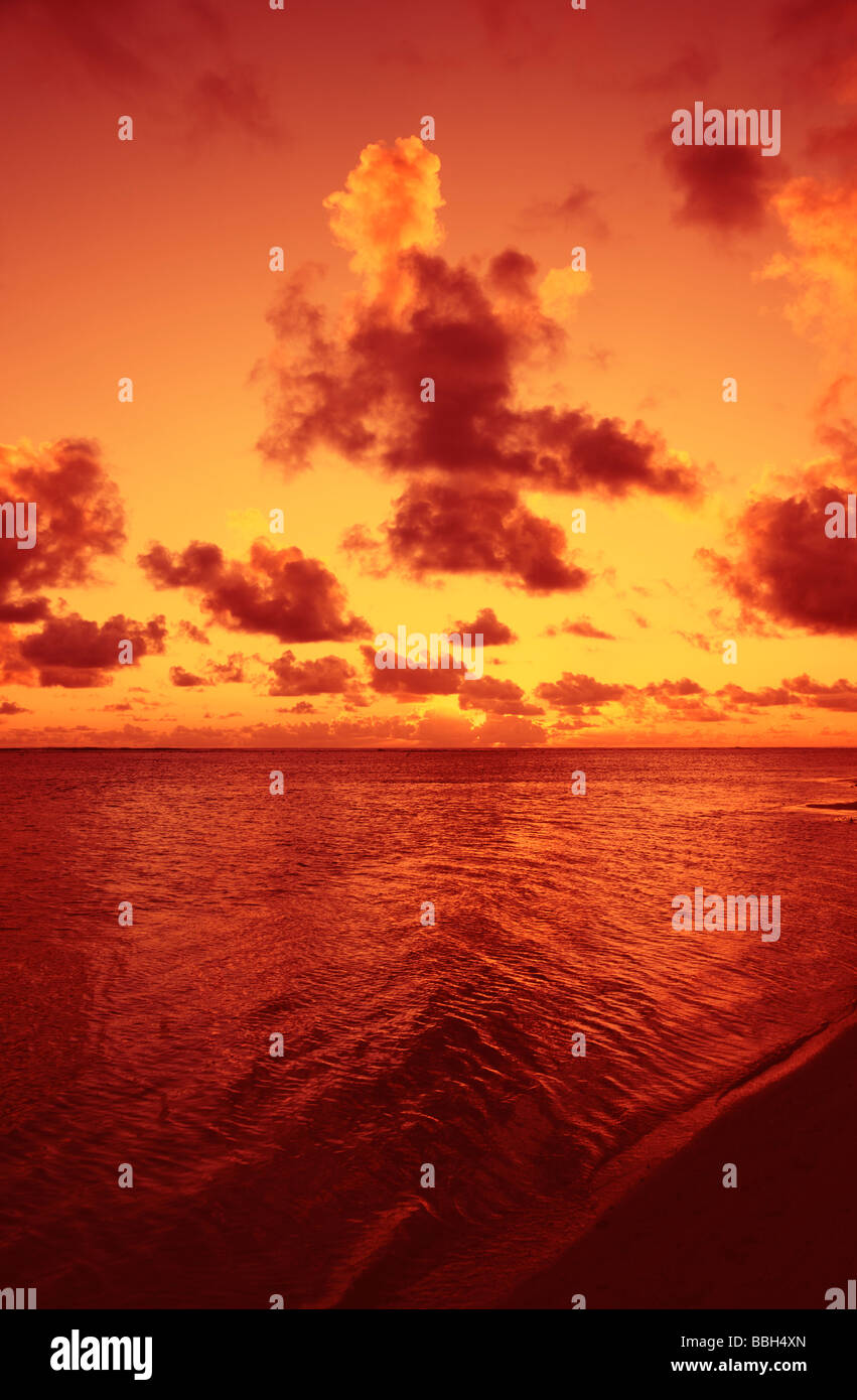 Sun setting behind Cumulus Clouds over Ocean and Island Rarotonga Cook ...