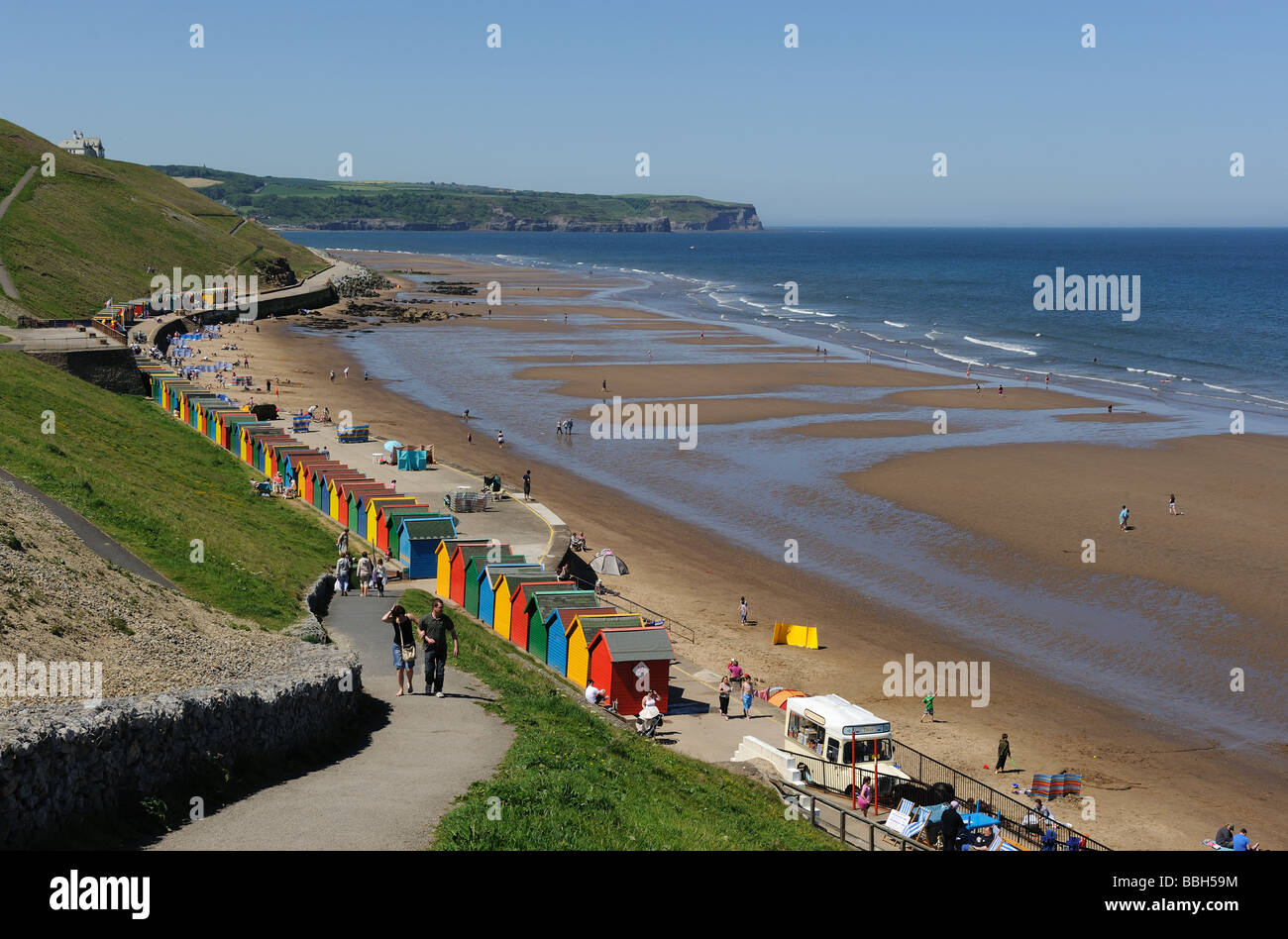 The fabulous beach at Whitby on a gorgeous summer's day. The beach huts ...
