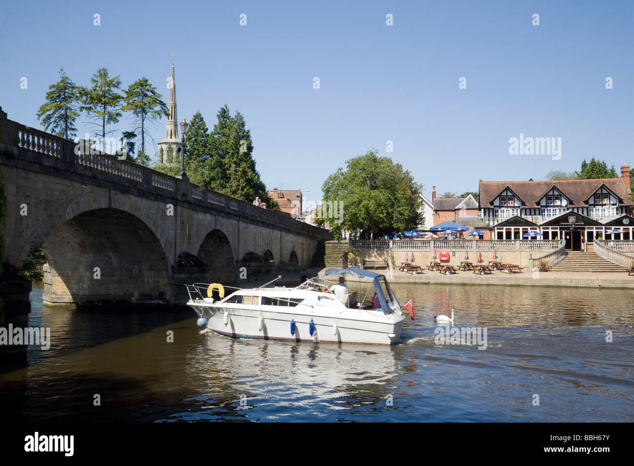 A motor boat heading under the bridge on the river Thames at ...