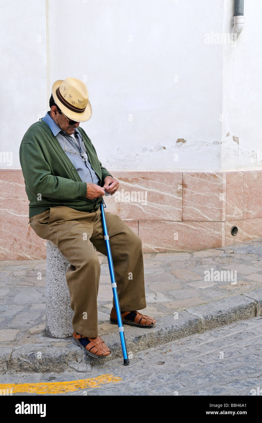 Older Spanish man sitting resting with walking stick Spain Stock Photo ...