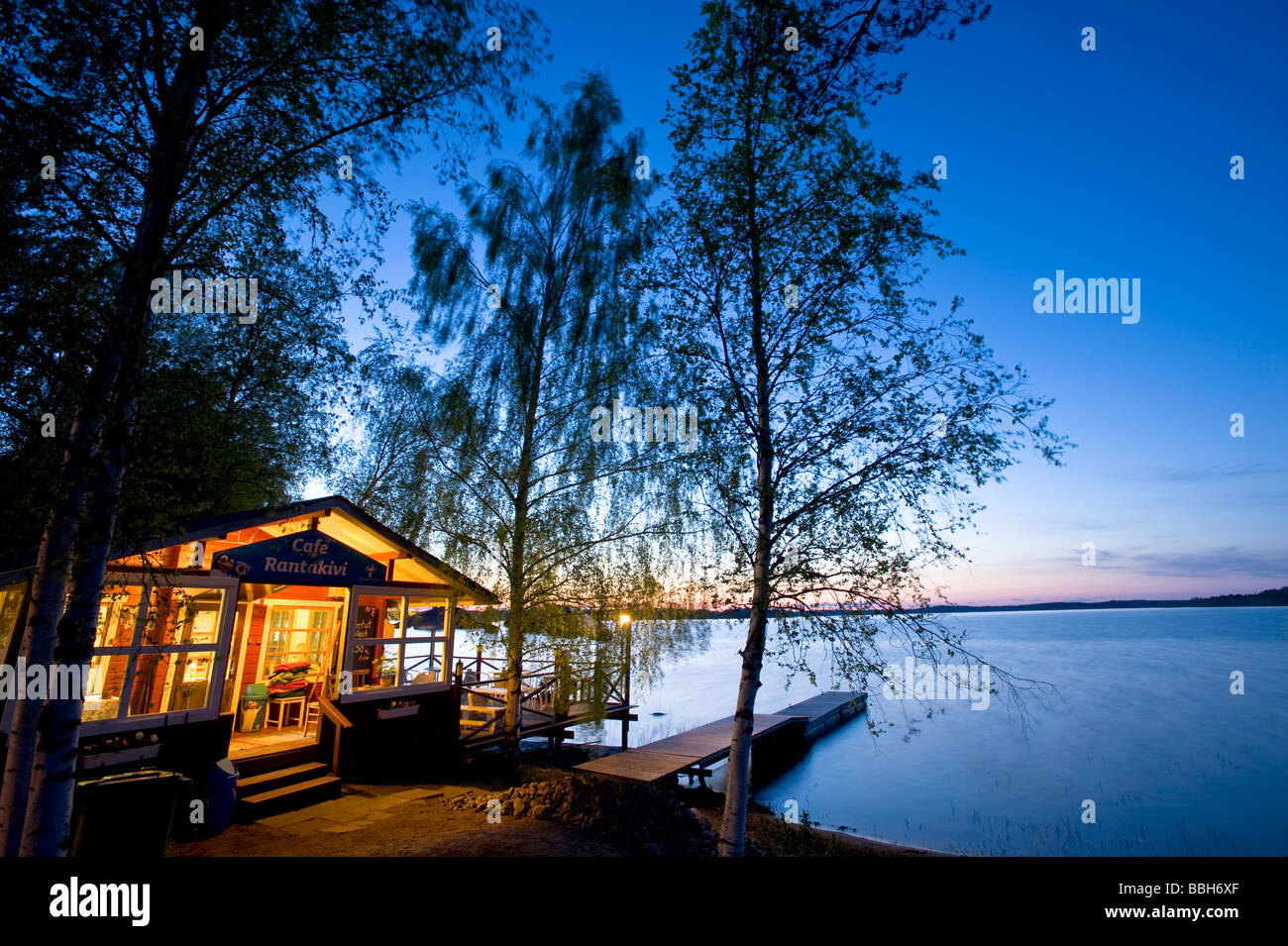 Cafe bar "Cafe Rantakivi Oy" by the lake at night Lakeland Karelia ...