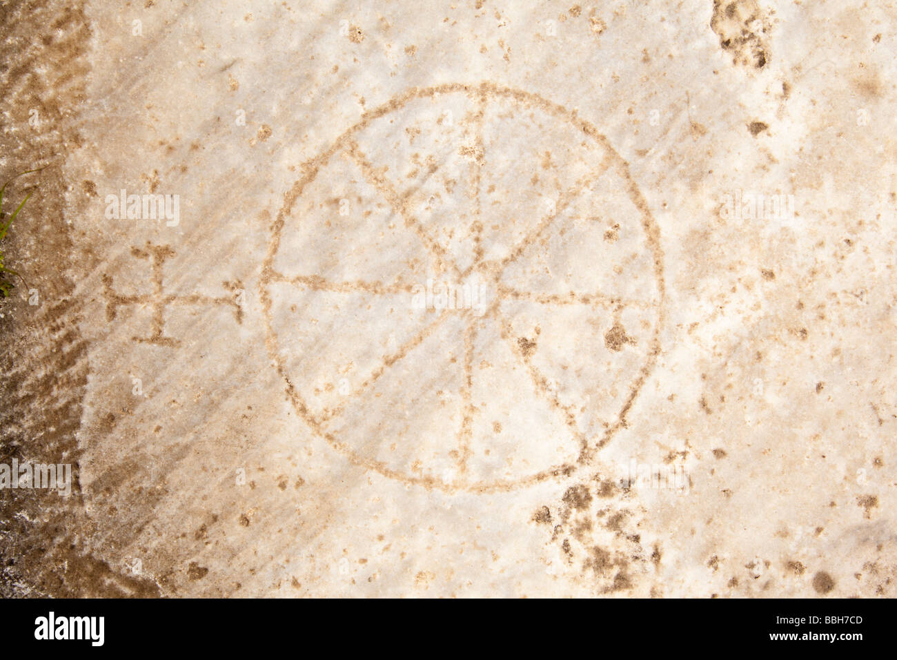 Ancient Christian cross and possibly a game carved into the marble ...