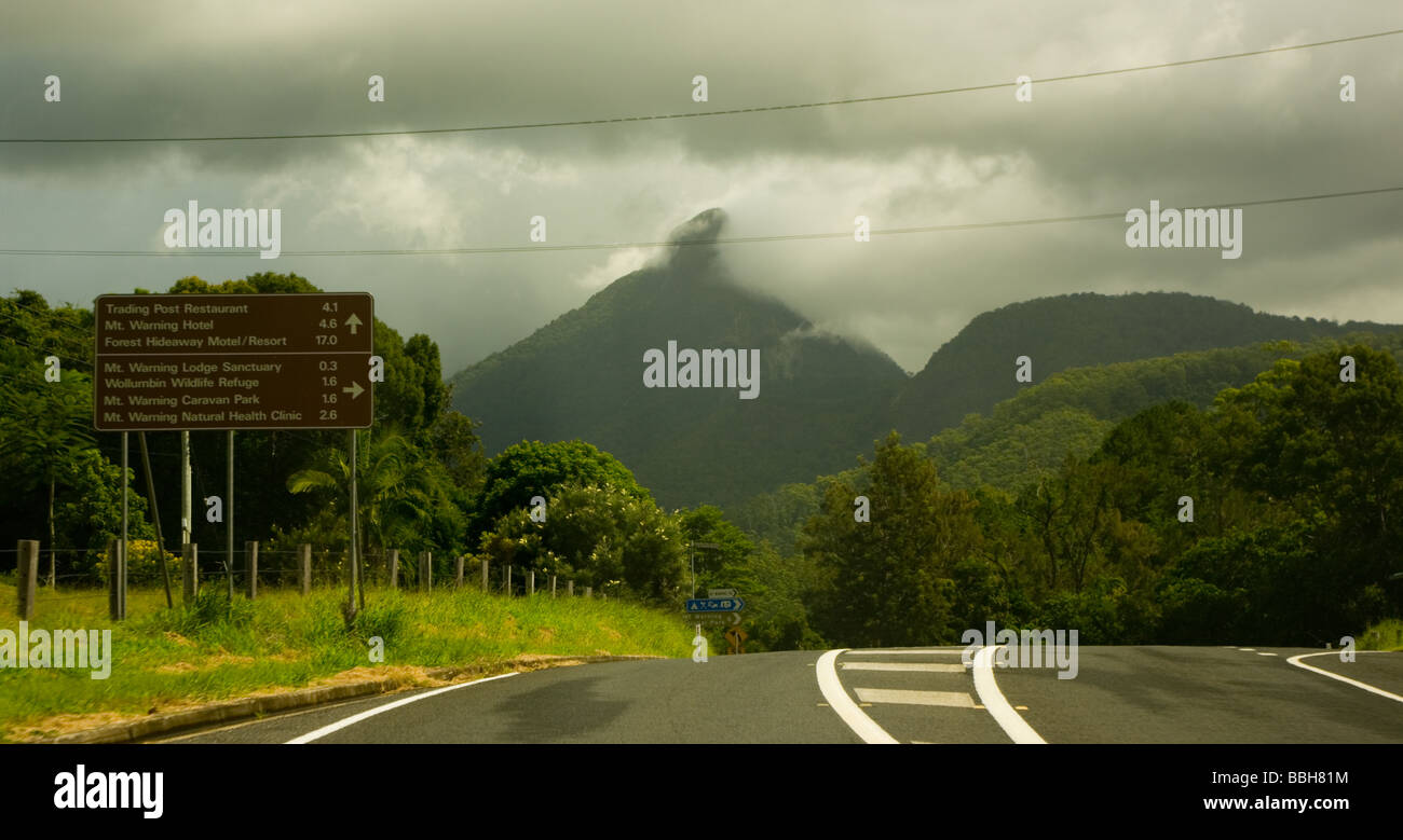 Mount Warning and road sign loom ahead Stock Photo - Alamy