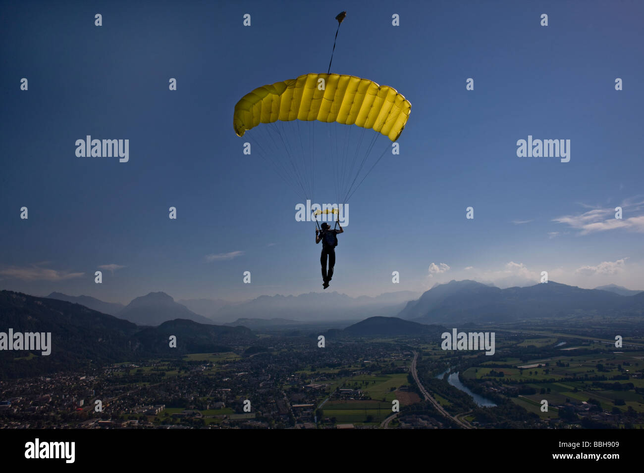 Skydiver is under the canopy flying over a spectacularly mountain ...