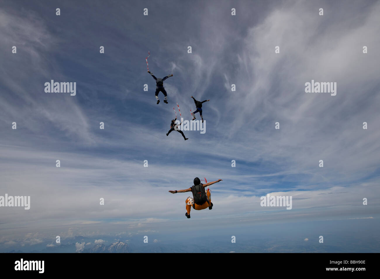 Skydivers are flying within a team in the sit fly position around each ...