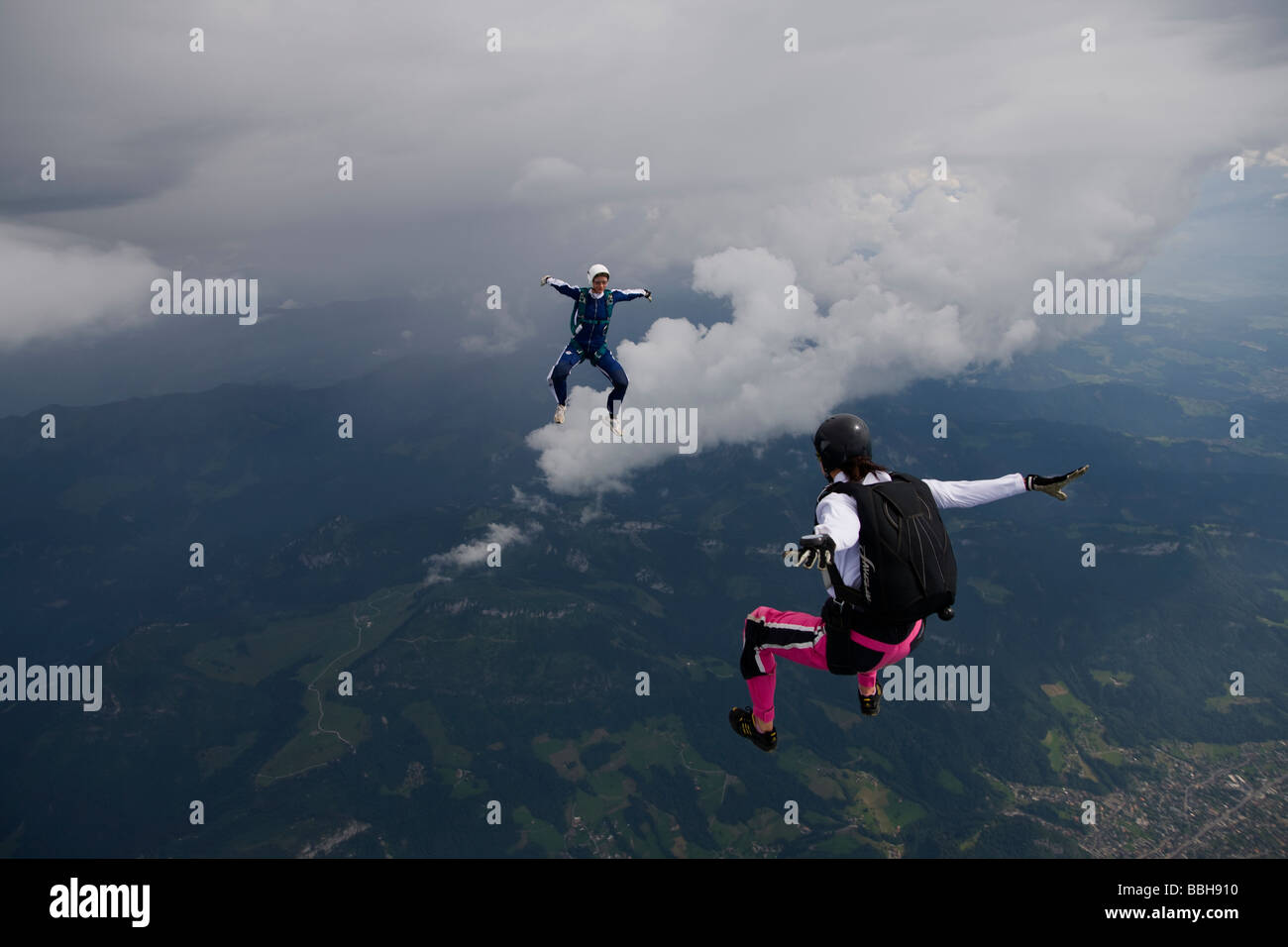 Skydivers are flying within a team in the sit fly position around each ...