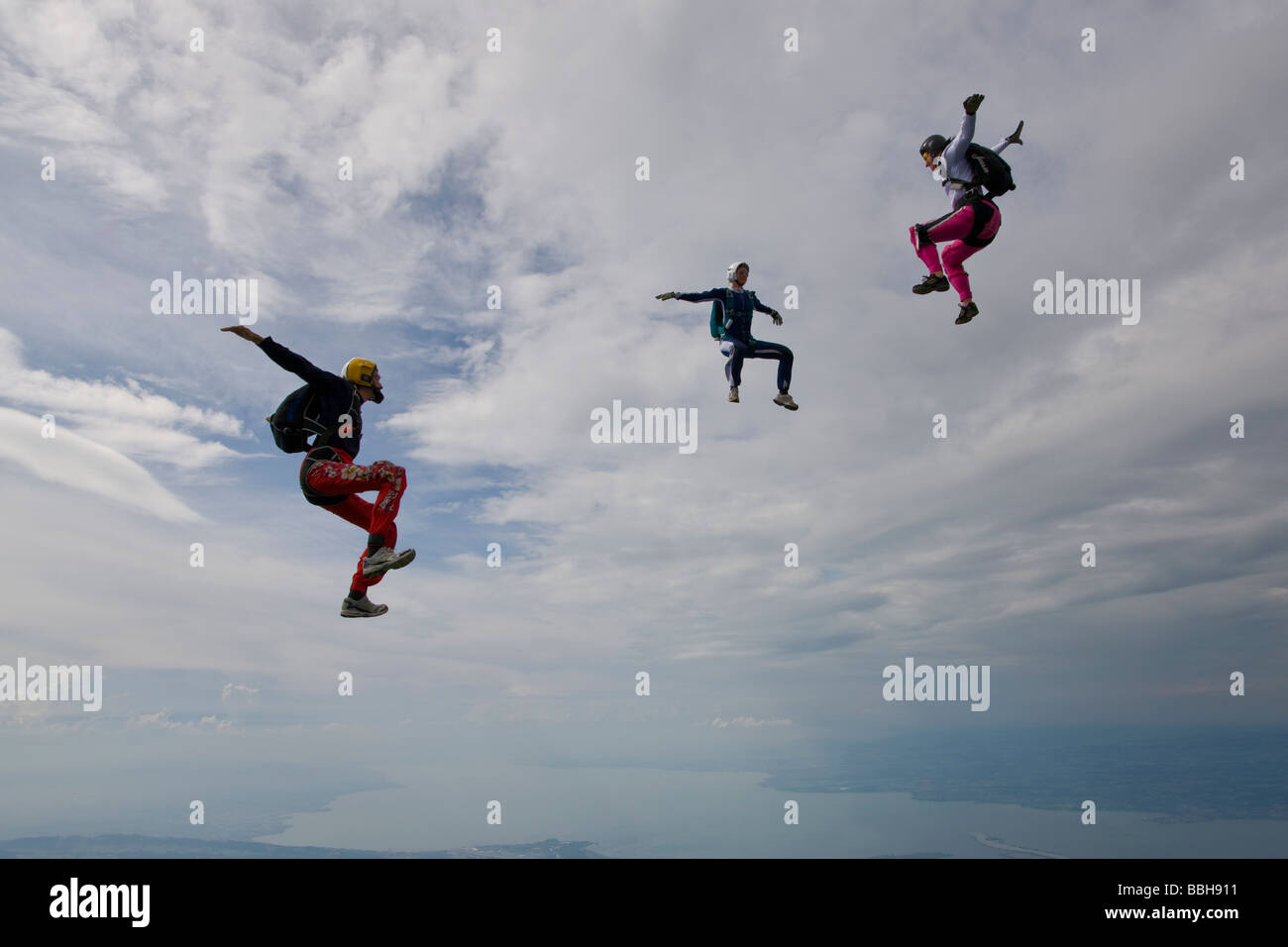 Skydivers are flying within a team in the sit fly position around each ...