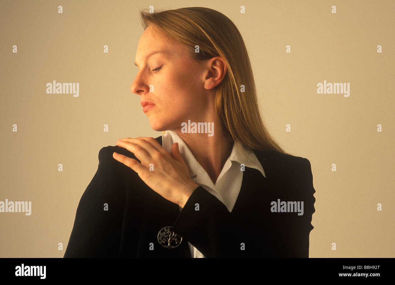 woman in a dark jacket brushing dandruff off her shoulder Stock Photo ...