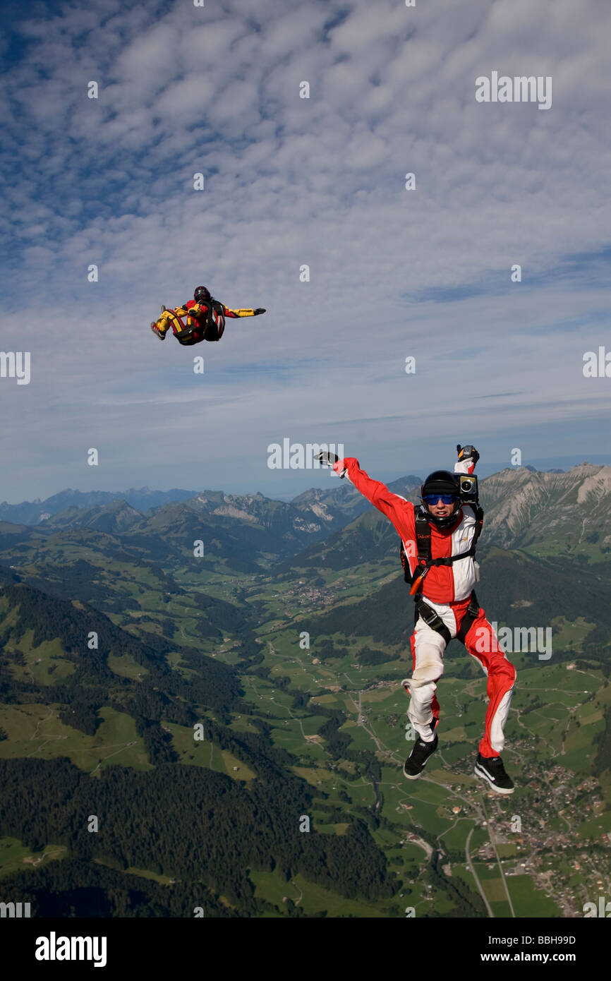 Skydiver are flying head up within a team in the sit fly position over ...