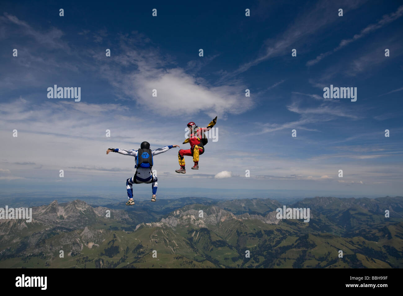 Skydiver are flying head up within a team in the sit fly position over ...