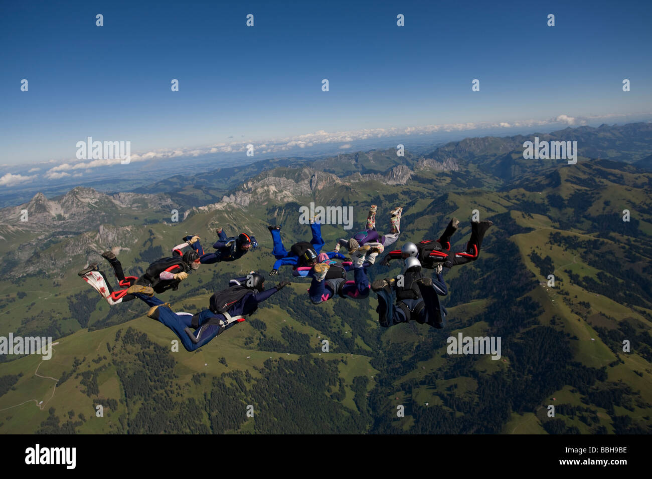Skydiver team is flying a formation in the sky over a spectacularly ...