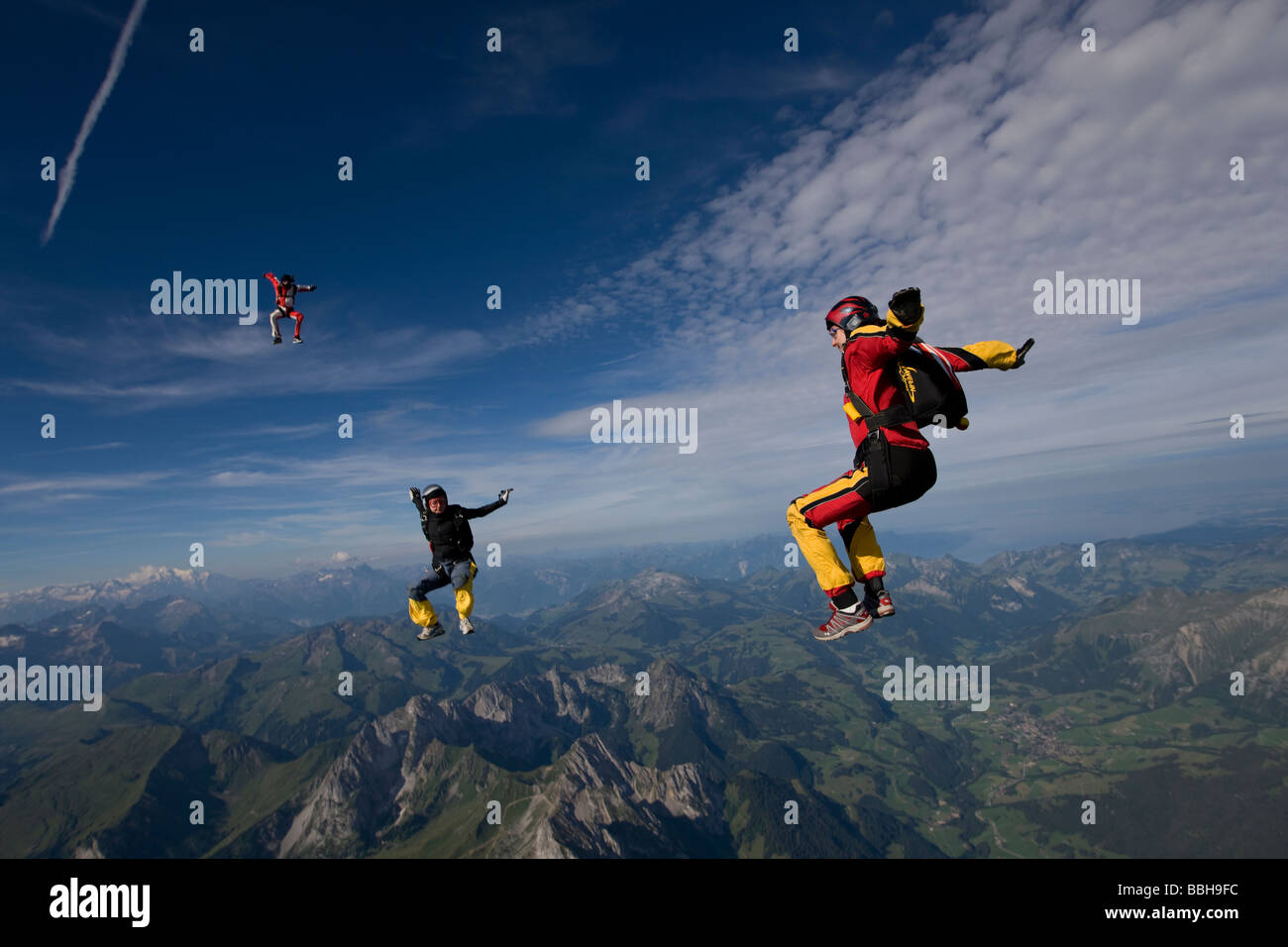 Skydiver are flying head up within a team in the sit fly position over ...