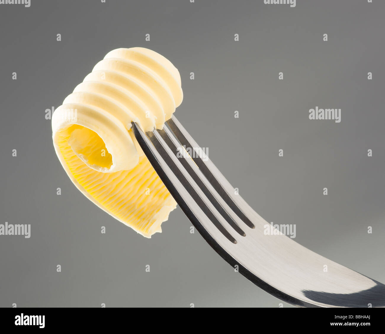 Butter curl on top of a metal fork Stock Photo - Alamy