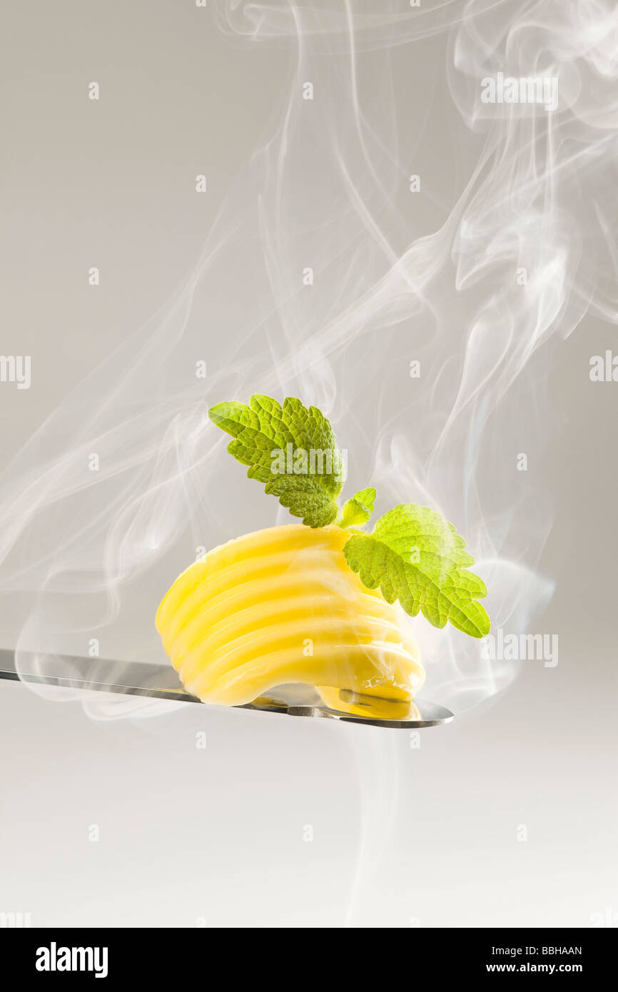 Butter curl on a knife melting in steam Stock Photo - Alamy
