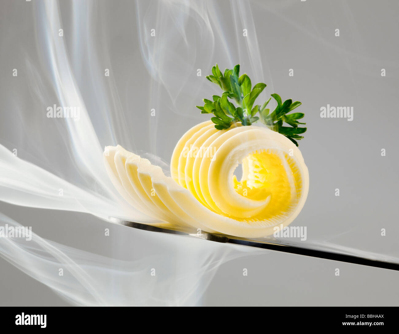 Butter curl on a knife in steam Stock Photo - Alamy