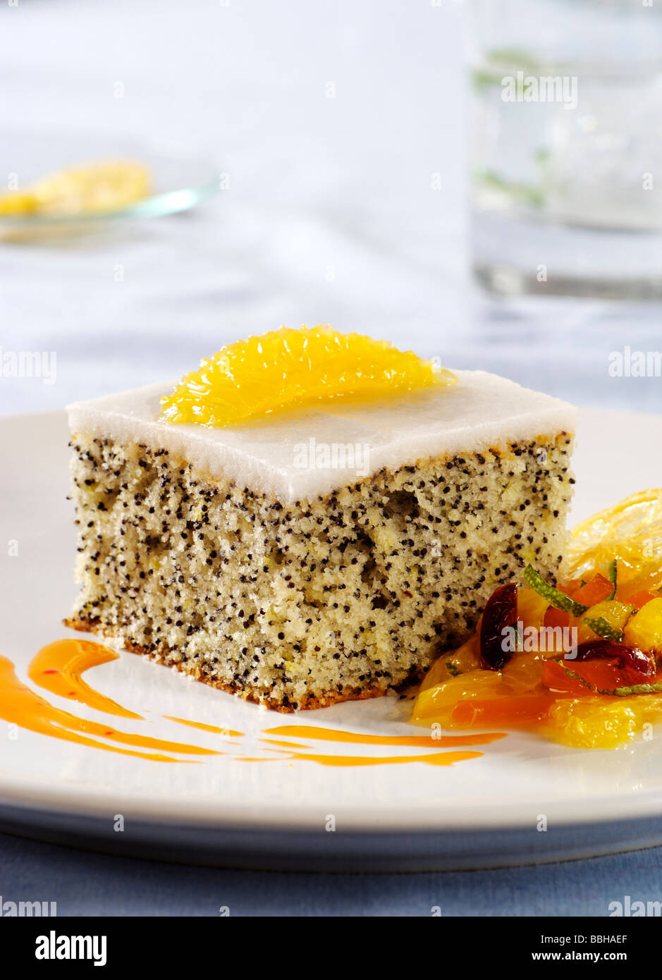 Poppy seed puff cake with icing served with fruit Stock Photo - Alamy