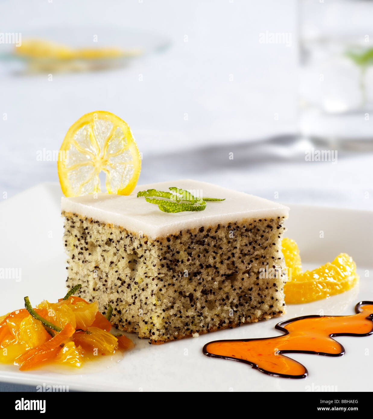 Poppy seed puff cake with icing served with fruit Stock Photo - Alamy