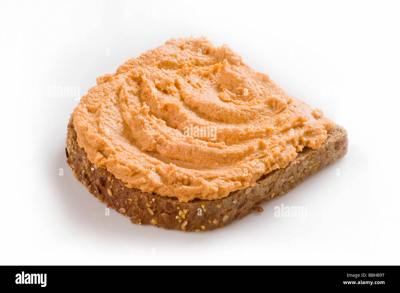 Slice of brown bread and spread Stock Photo - Alamy