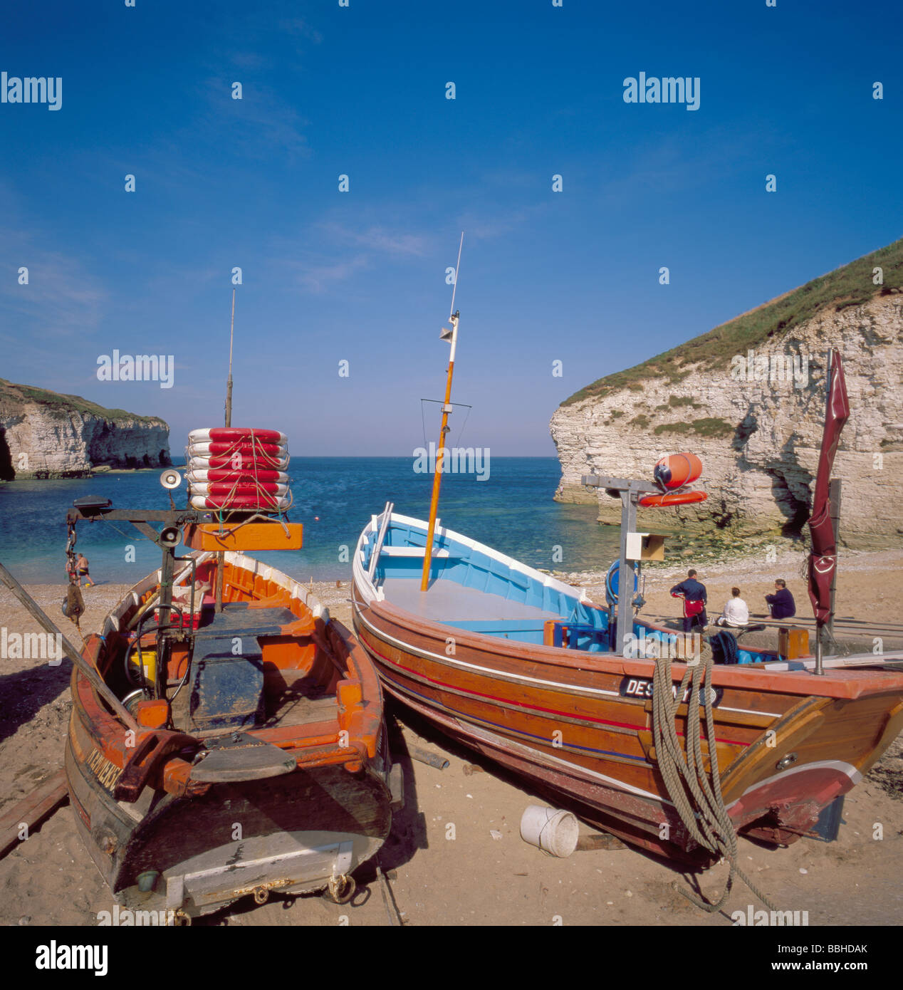 Coble fishing boats with chalk cliffs of Thornwick Nab beyond, North ...