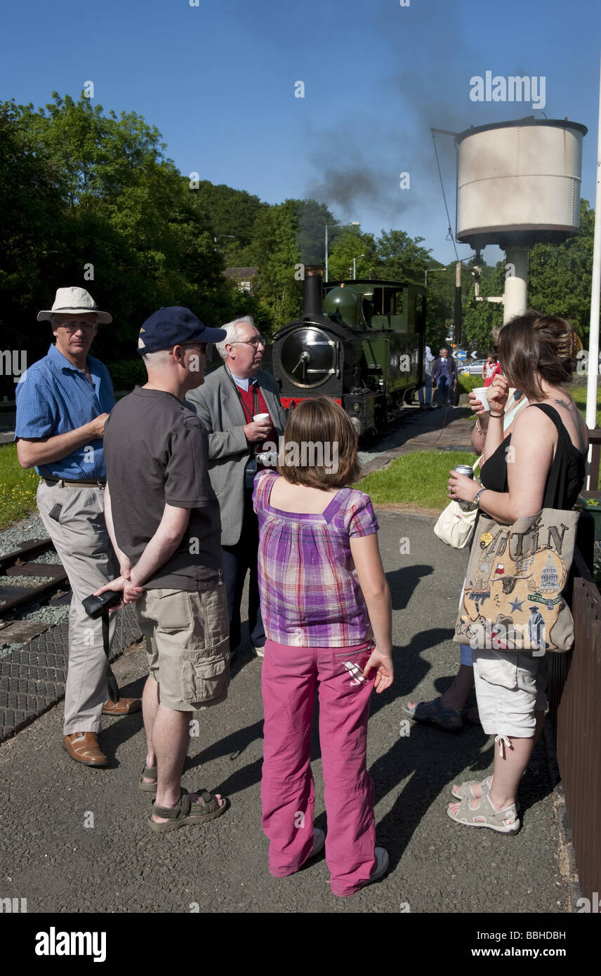 Tourists watch as engineer refills Steam Engine with water on the ...