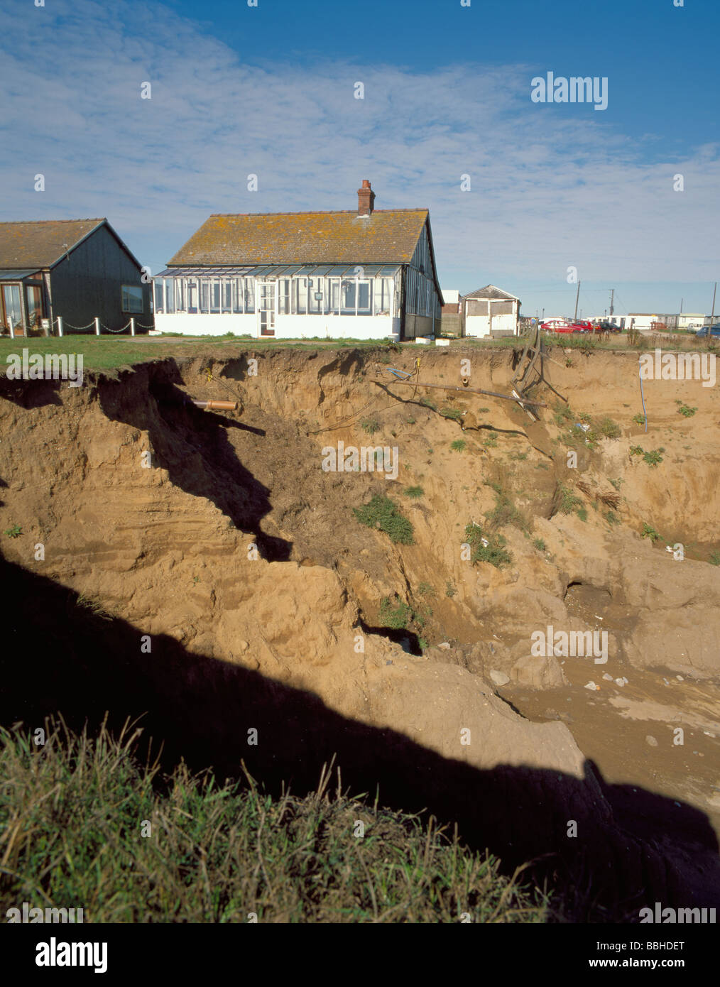 Abandoned cottage perched on an eroding cliff edge, Barmston, south of ...