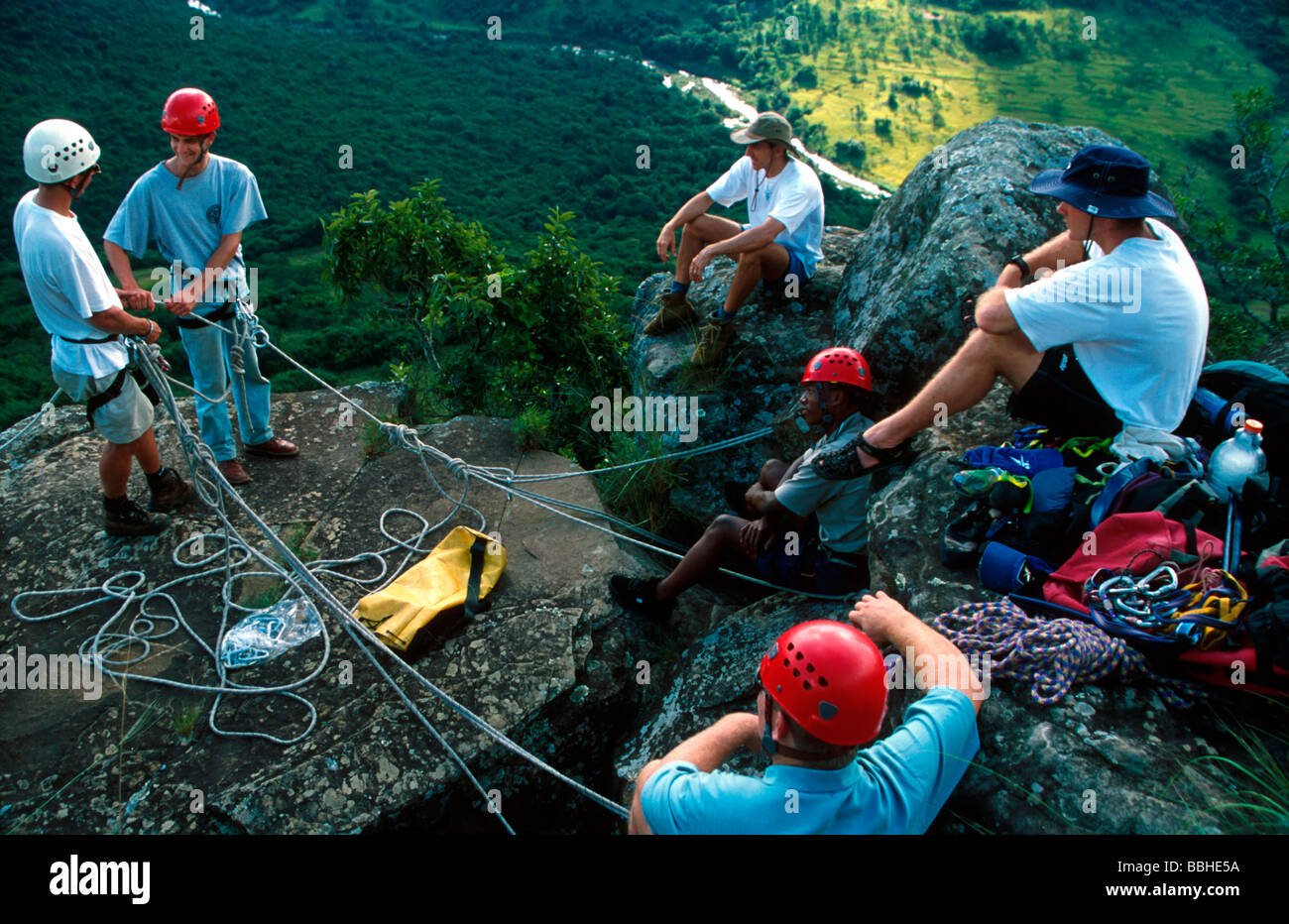 Abseiling guides receive instruction on rope techniques at a crag on ...