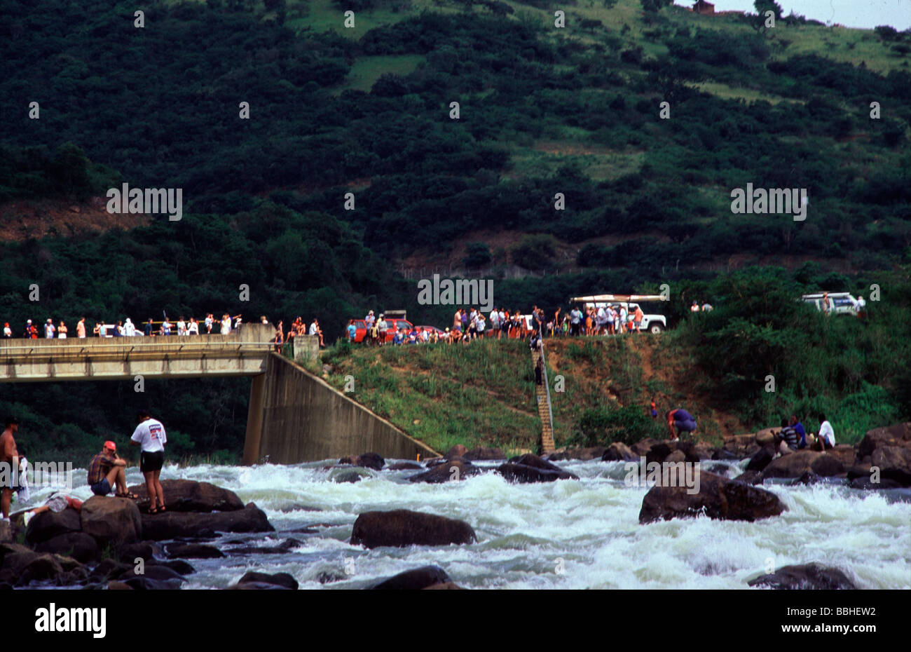 Spectators crowd the bridge below Inanda Dam wall to view paddlers ...