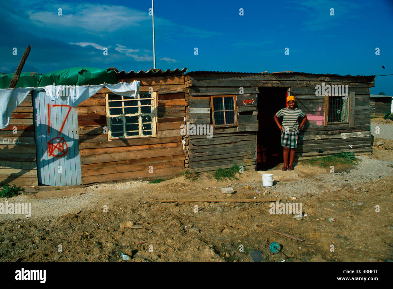 A woman stands outside her shack at Silahliwe the area to where those ...