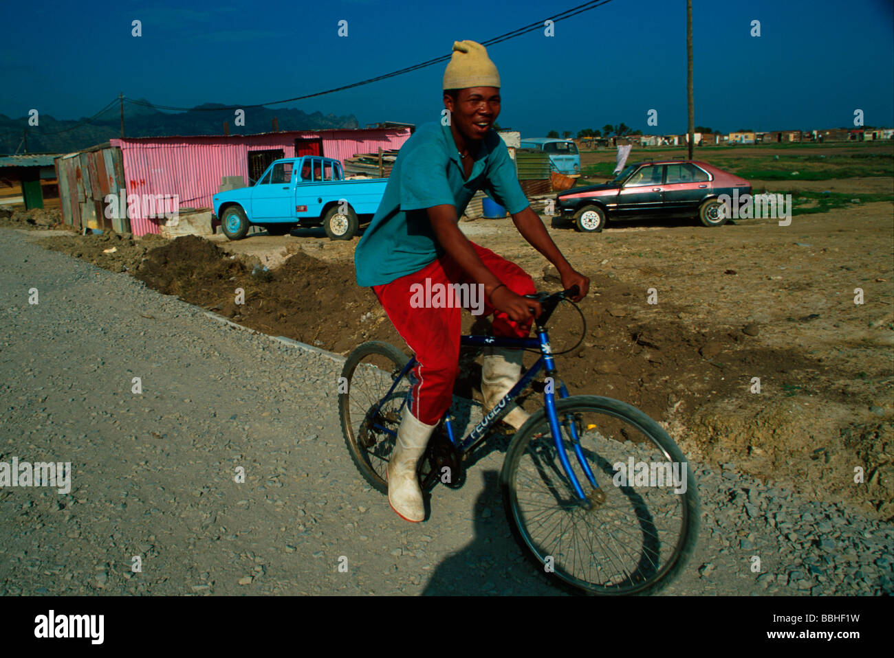 A young man cycles past Silahliwe the area to where those who did not ...