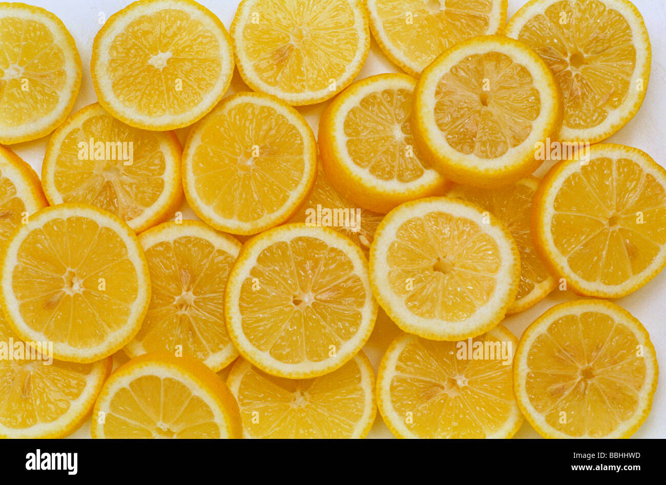 Slices of lemons on a plain background Stock Photo - Alamy