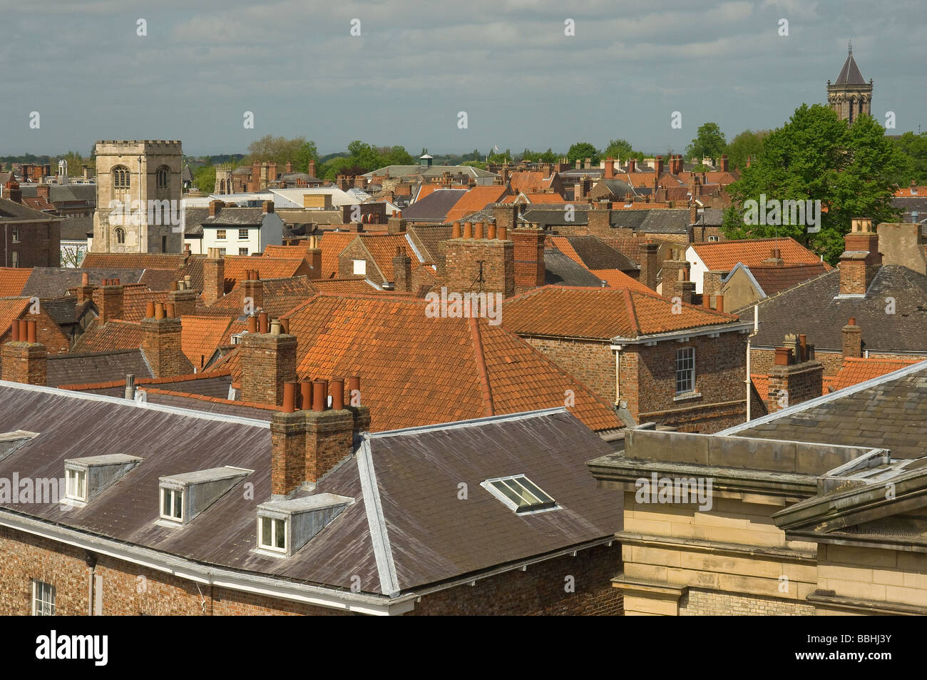 View across rooftops of houses and buildings in the city town centre ...