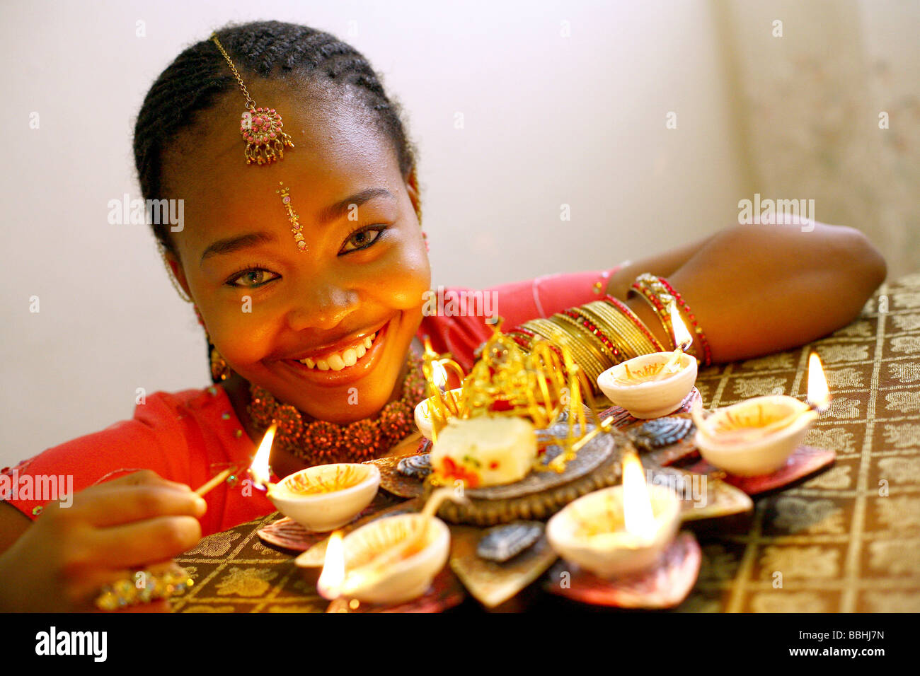 12 year old Hindu devotee Latoya Khaba lights clay lamps on 21 October ...