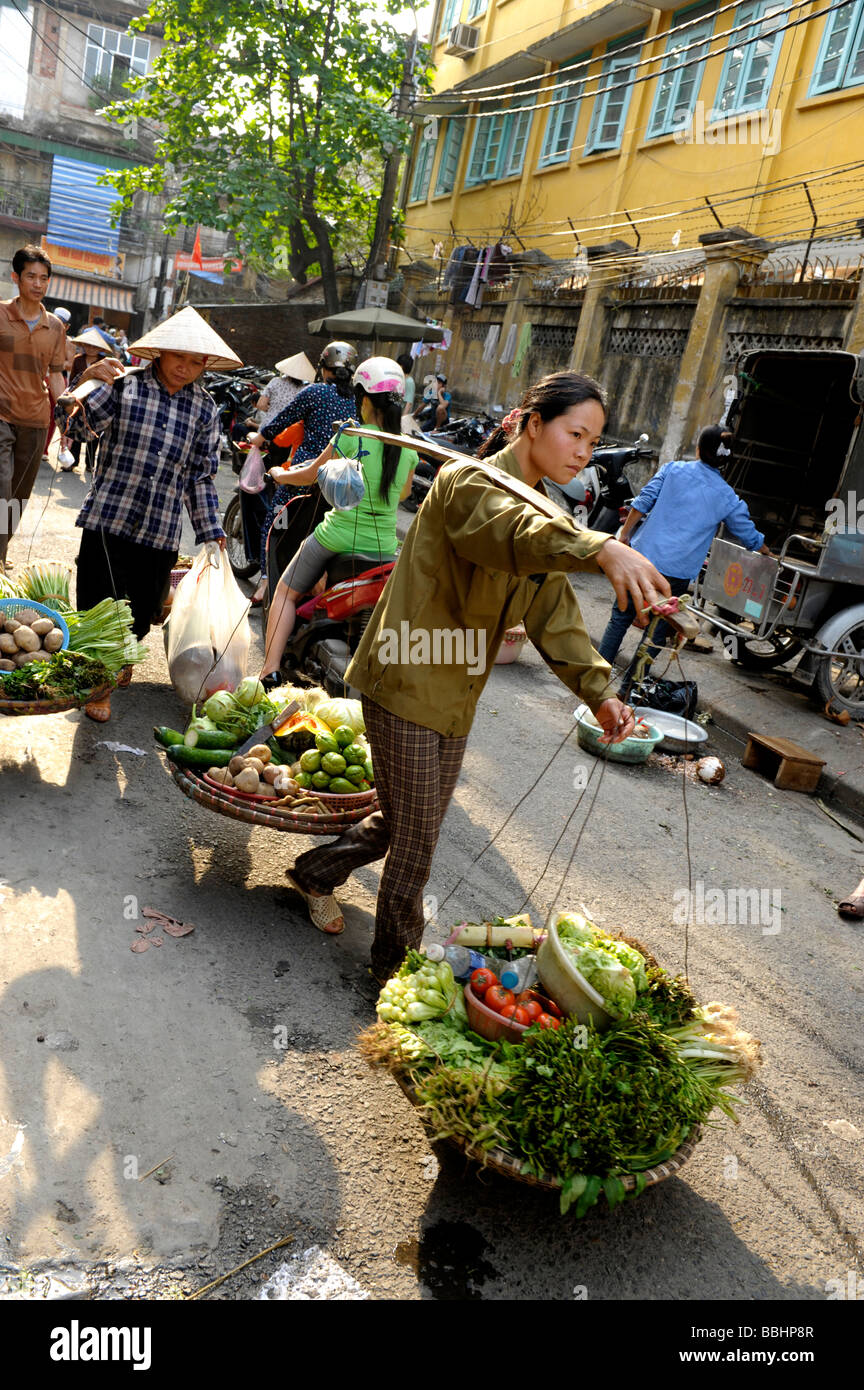 Street hawker carrying vegetable to sell in old Quarter Hanoi, Vietnam ...
