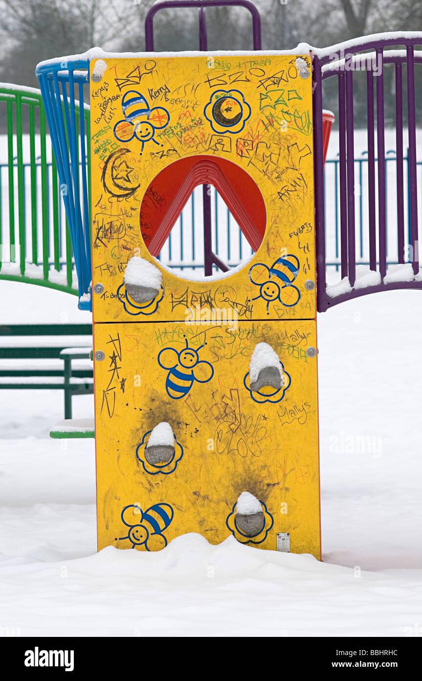 a playground with graffiti written all over the climbing frame Stock ...