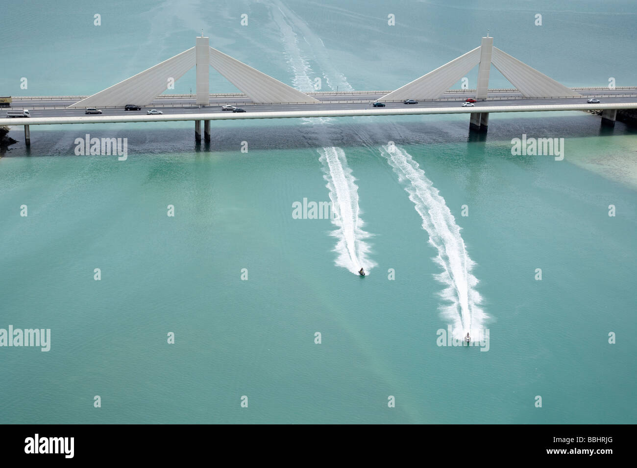 2 Jet skis passing under the causeway in Bahrain Stock Photo - Alamy