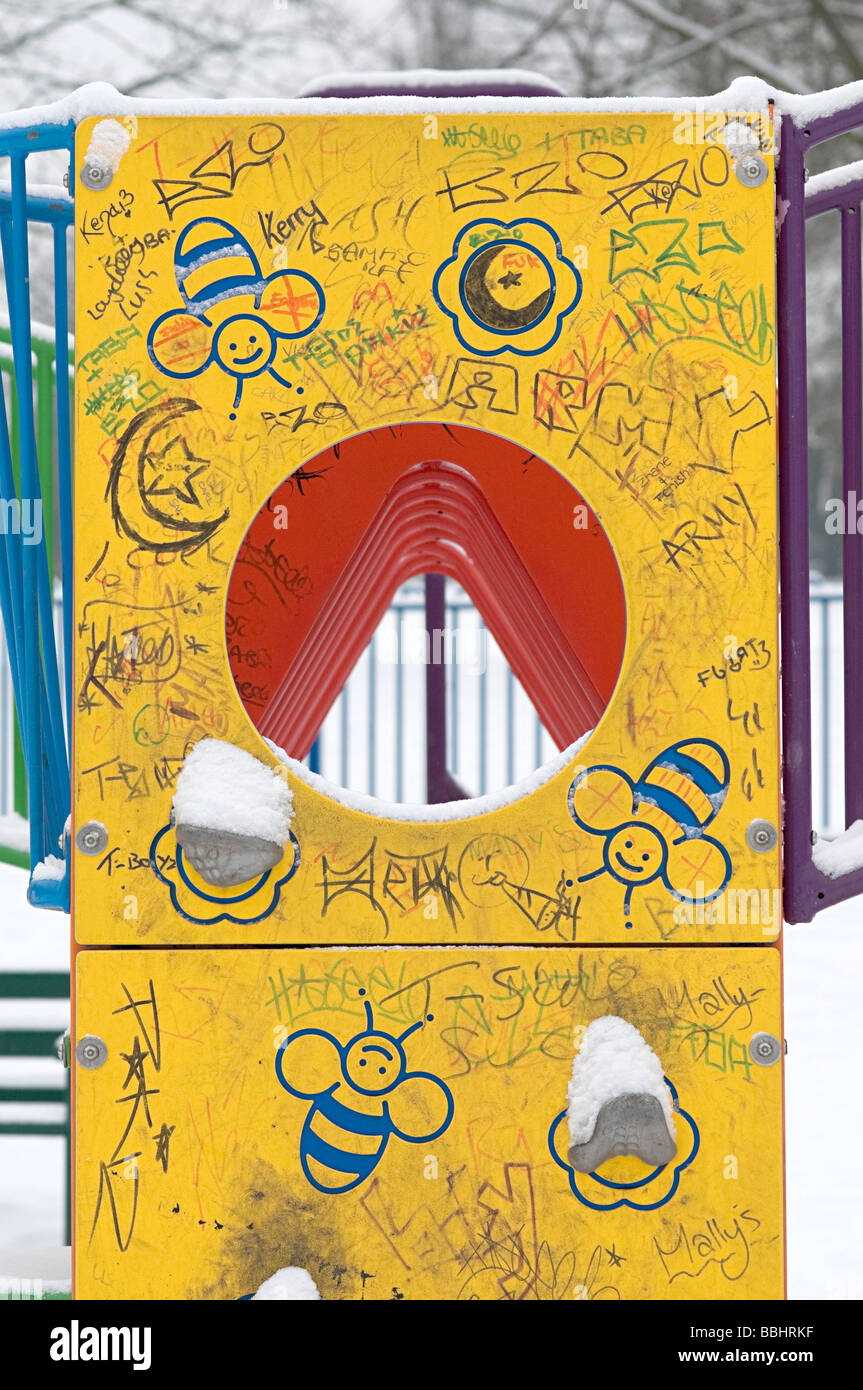 a playground with graffiti written all over the climbing frame Stock ...
