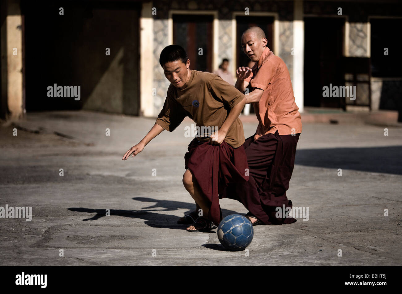 Young buddhist monks playing soccer hi-res stock photography and images ...