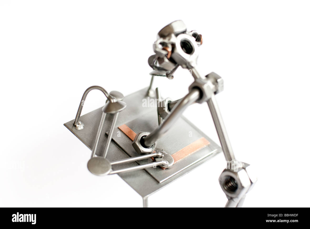 metal figure of an architect at his drawing board, the board is in ...