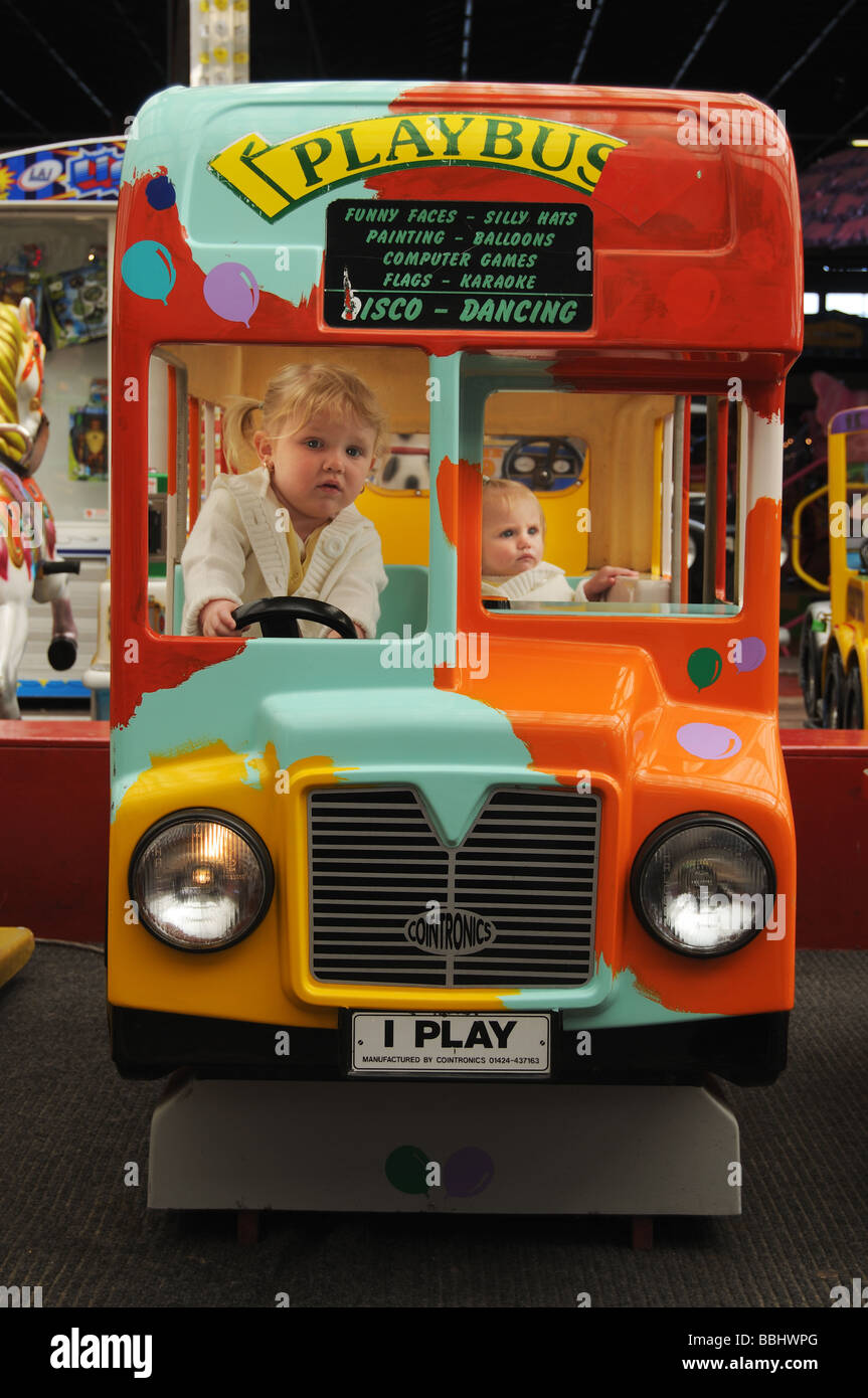 Two young girls in a play bus Stock Photo - Alamy