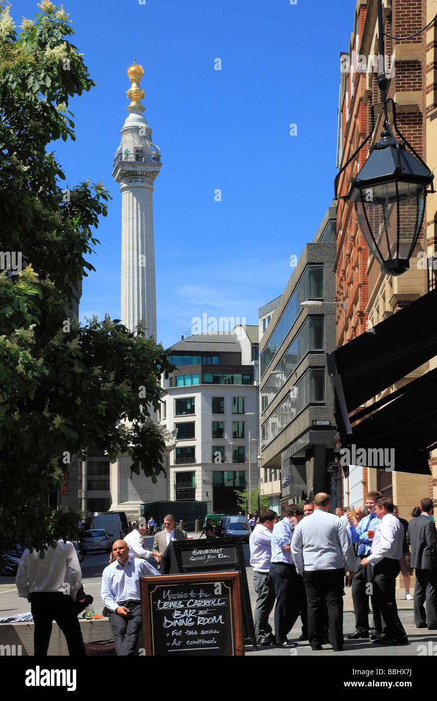 The Monument and people drinking outside the pub City of London England ...