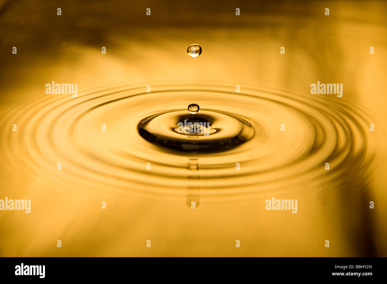 Two drops of water falling. Making small waves on the surface Stock ...