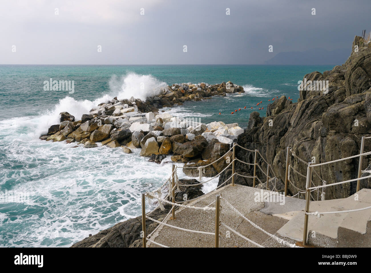 The surf breaker at the entrance to the harbor of the small village of ...