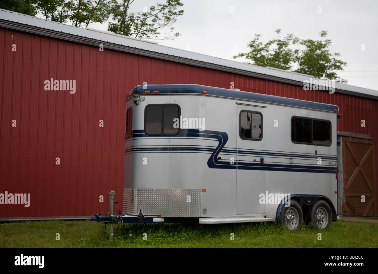 Horse trailer by the side of a barn Stock Photo - Alamy