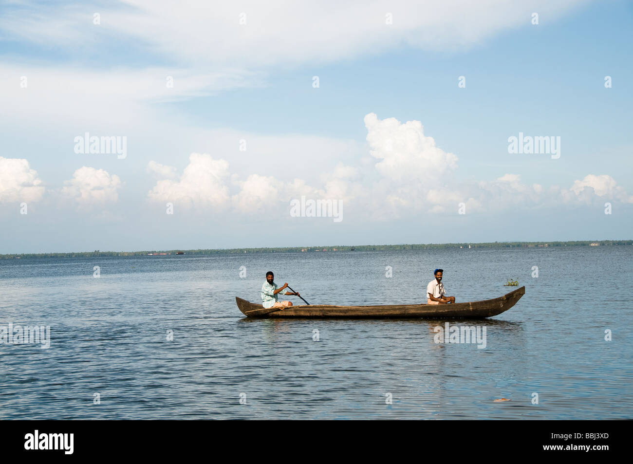 Indian fisherman in rowing boat fishing on lake, backwaters kerala ...