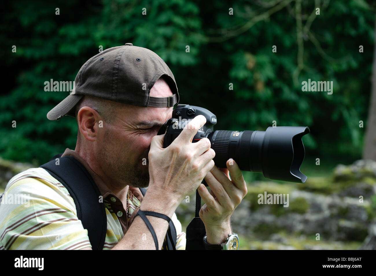 Man using Nikon D3 digital SLR camera to take a photograph Stock Photo ...