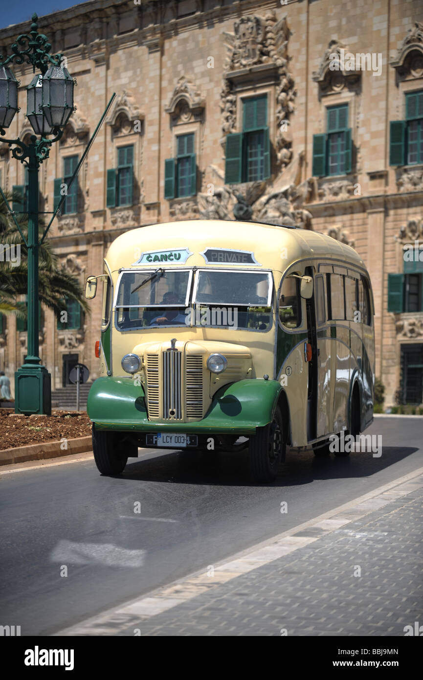 A vintage Maltese bus drives past the Auberge de Castille in Valletta ...