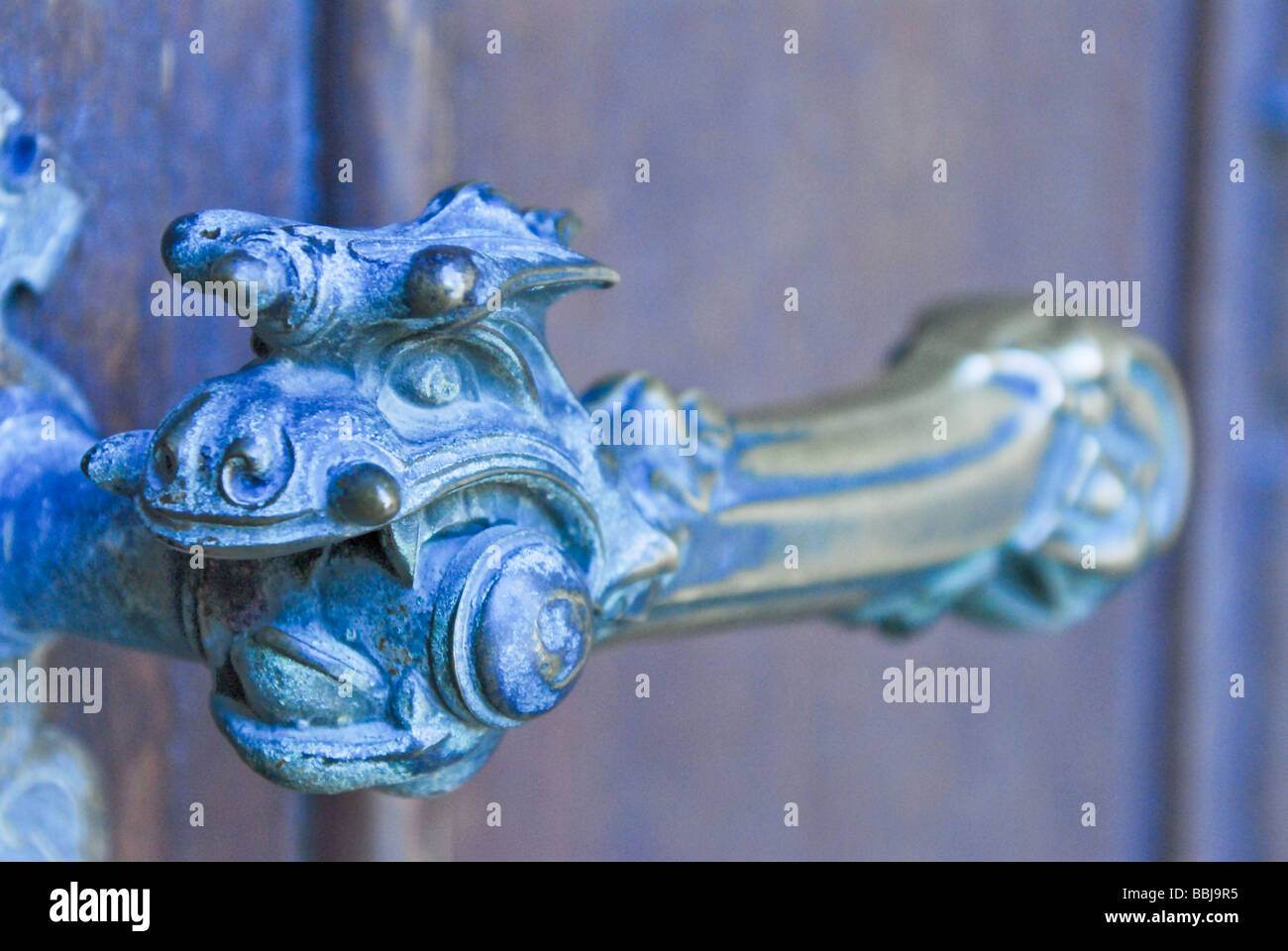 Hackneyed brass door handle at the entry gate of monastery Stift Admont ...