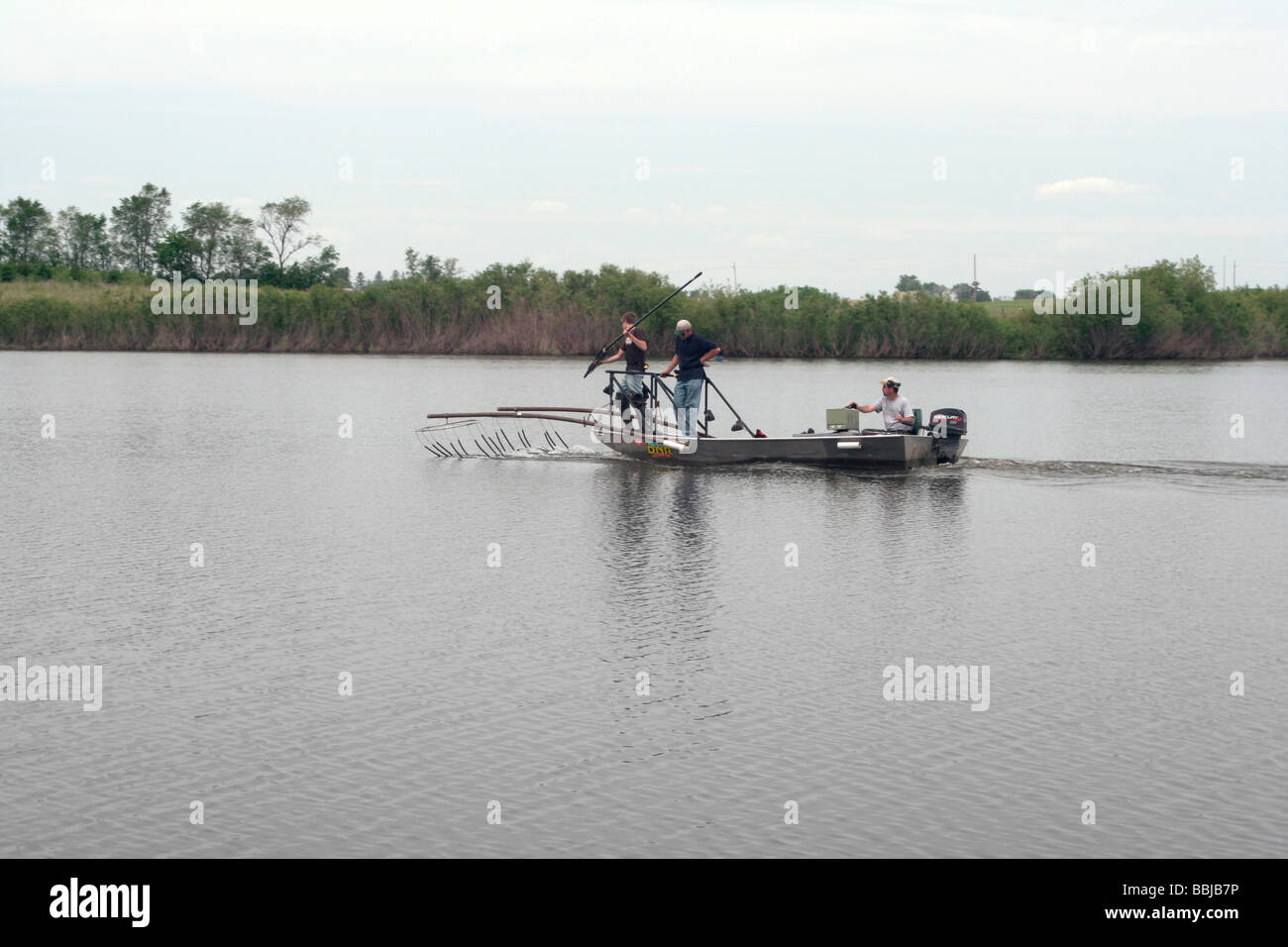 Electrodes to stun fish hang in front of an Iowa DNR Fisheries boat ...