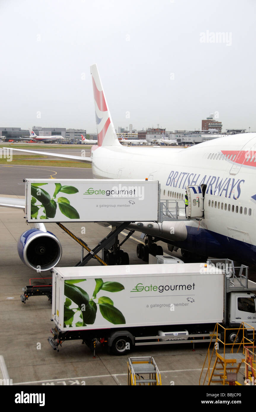 Gategourmet catering supplier trucks loading a BA 747 jet aircraft at ...